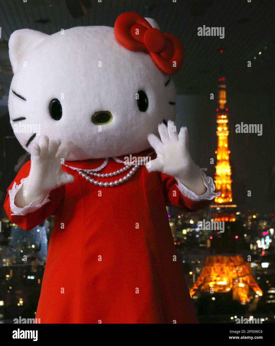 Hello Kitty poses after lighting up Tokyo Tower with an orange color ...