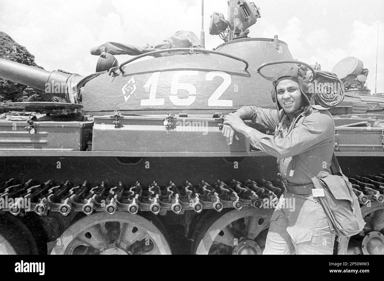 A soldier poses for a photo next to a tank during military exercises in ...