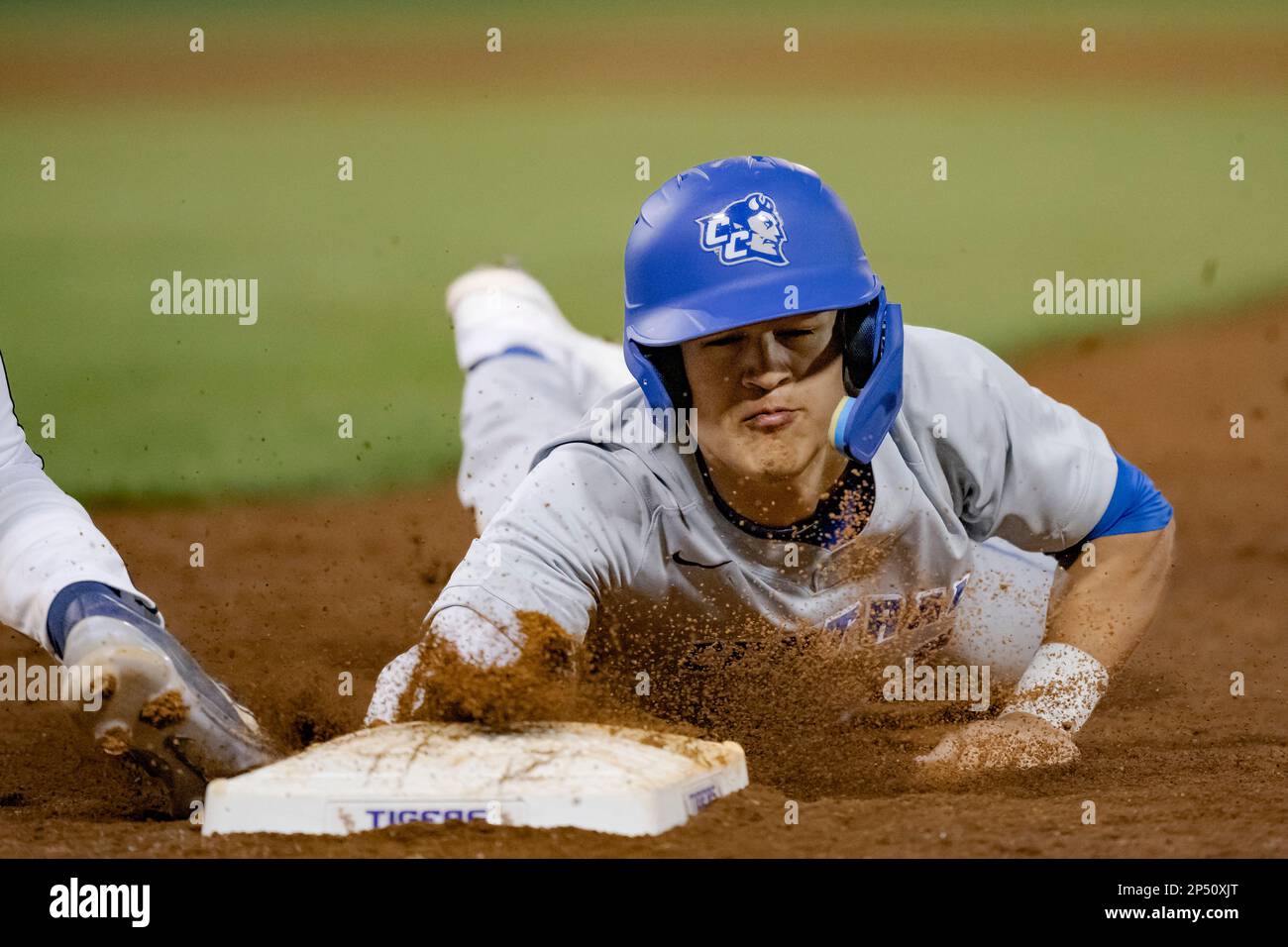 Central Connecticut State outfielder Kyle Gordon (8) slides back to ...