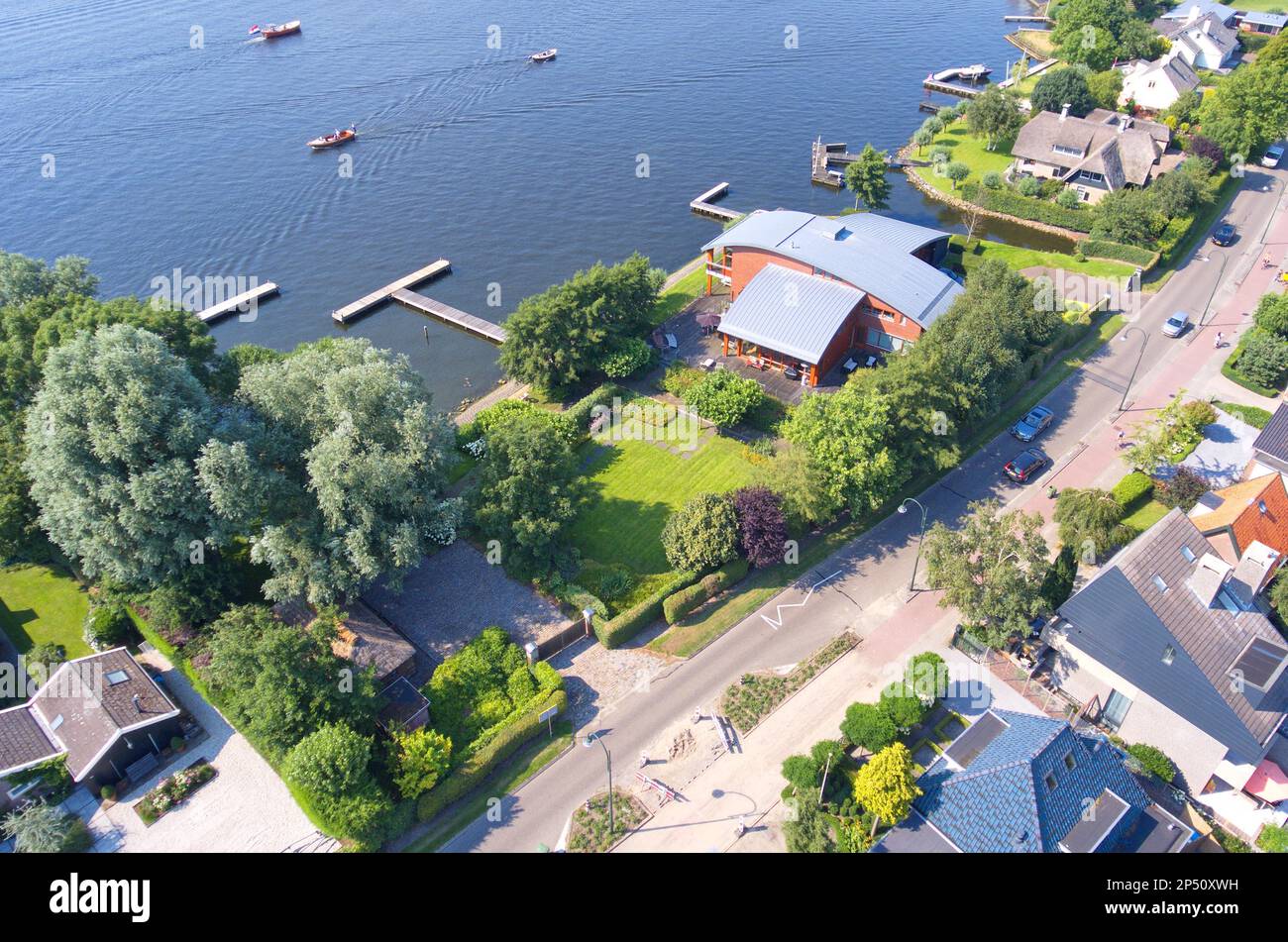 an aerial view of a small town by the water's edge with houses and ...