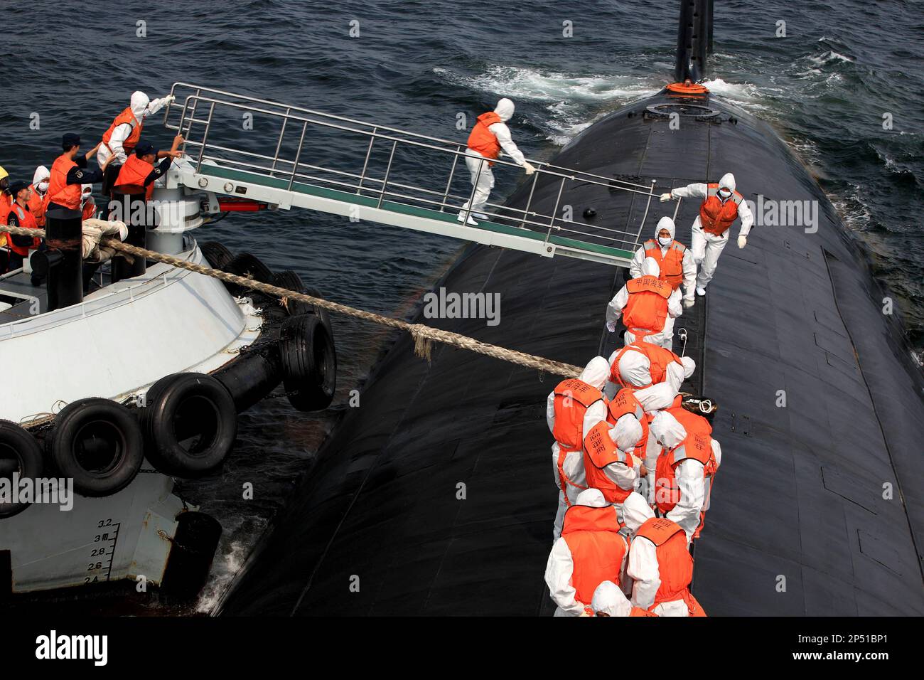 Soldiers take part in a safety drill on a nuclear submarine in Qingdao ...