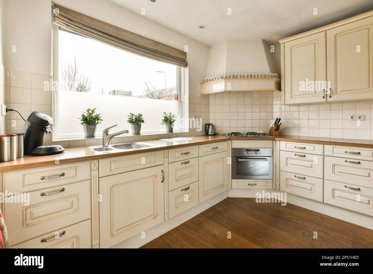 a kitchen with white cabinets and wood counter tops on the counters in ...