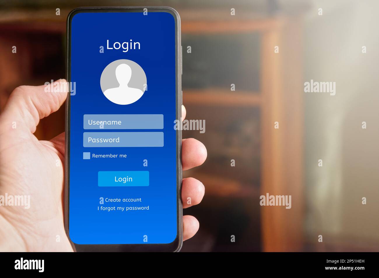 Man holding mobile phone showing login interface on mobile phone screen ...