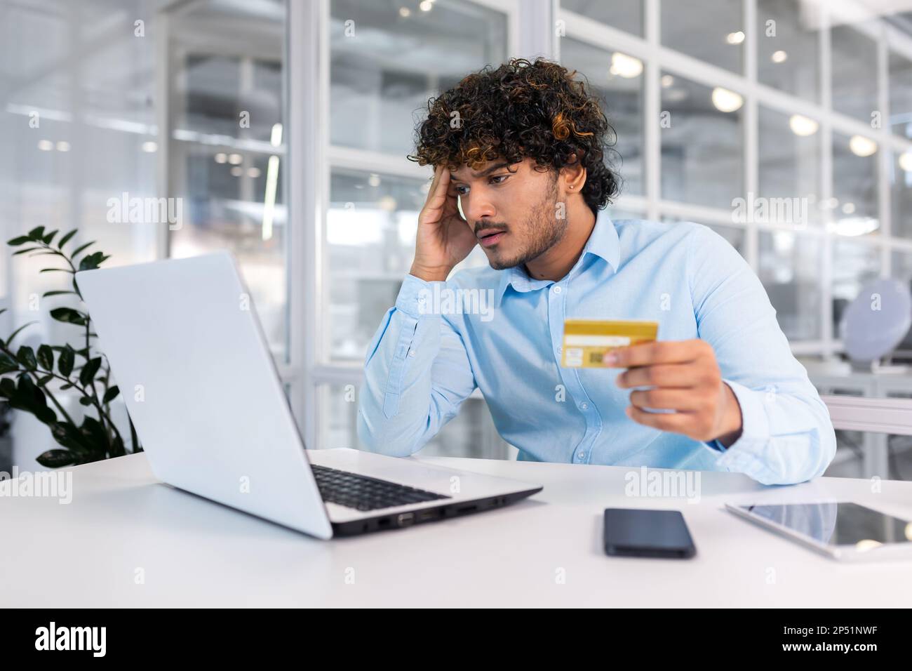 Upset and deceived businessman inside office trying to transfer money ...