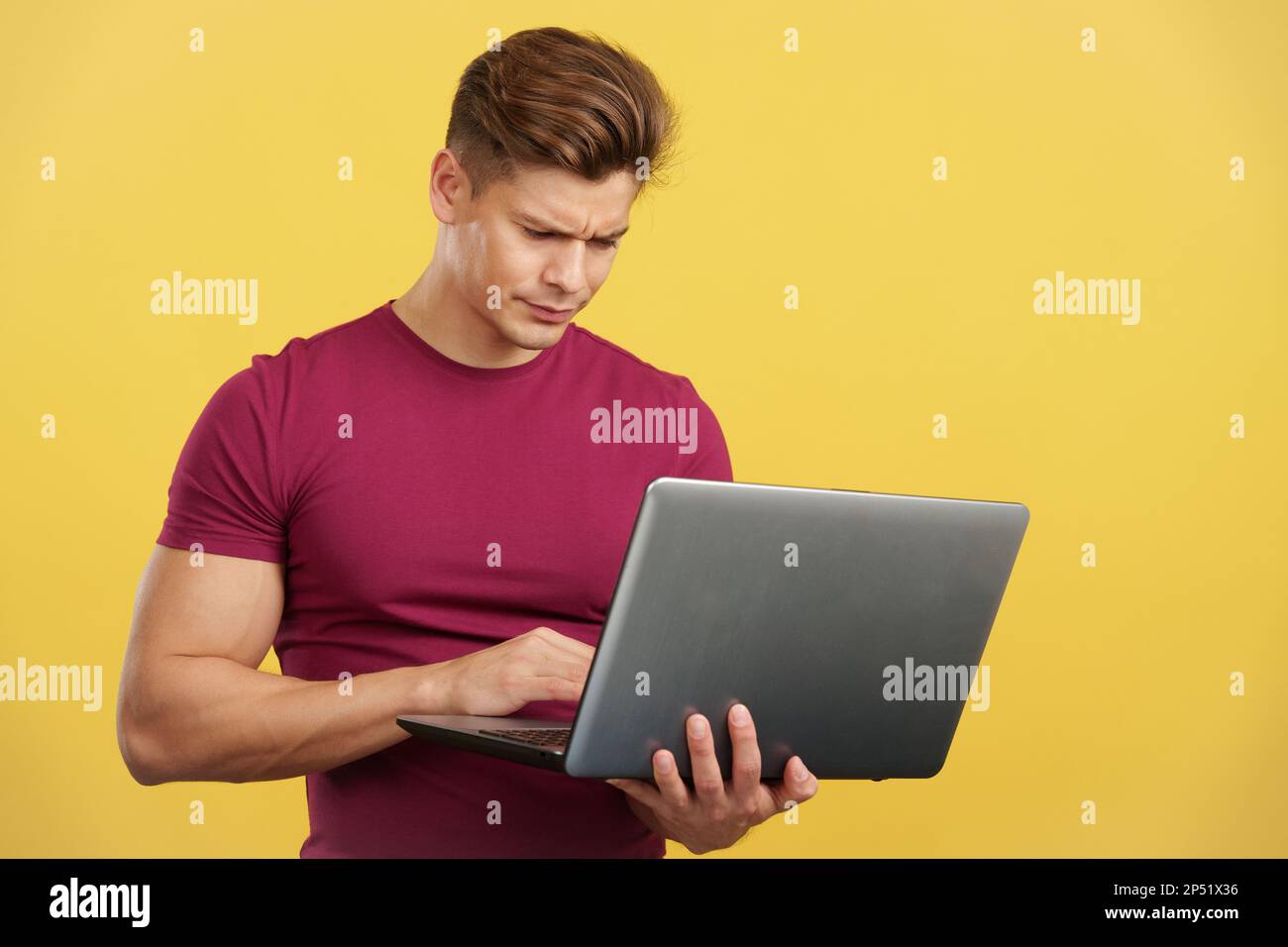 Strong man having a problem while using a laptop Stock Photo - Alamy