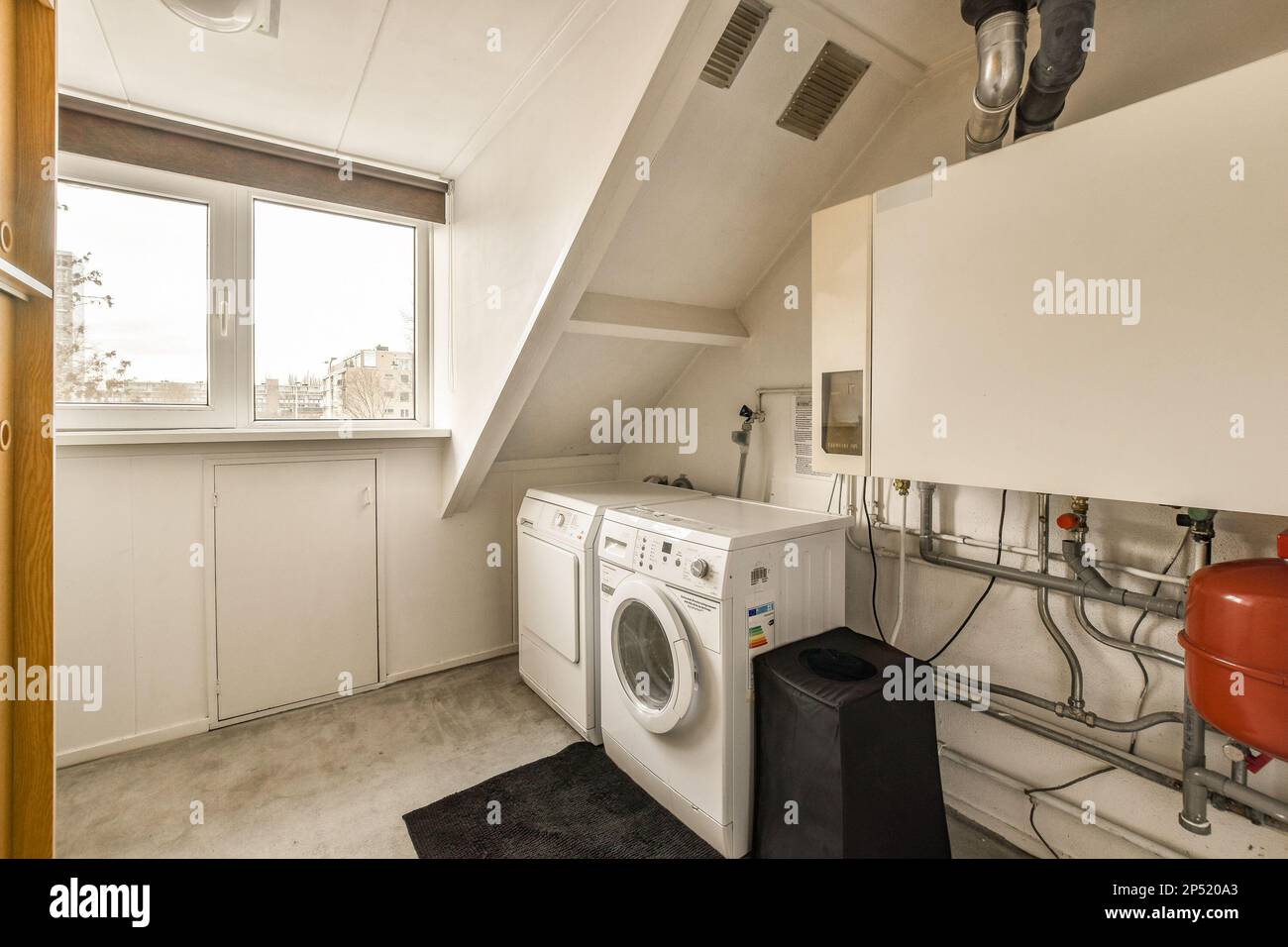 a laundry room with a washer, dryer and washing machine in the corner ...