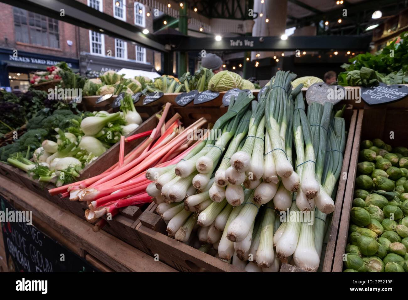 Spring onions for sale at market stall at Borough Market, partially ...