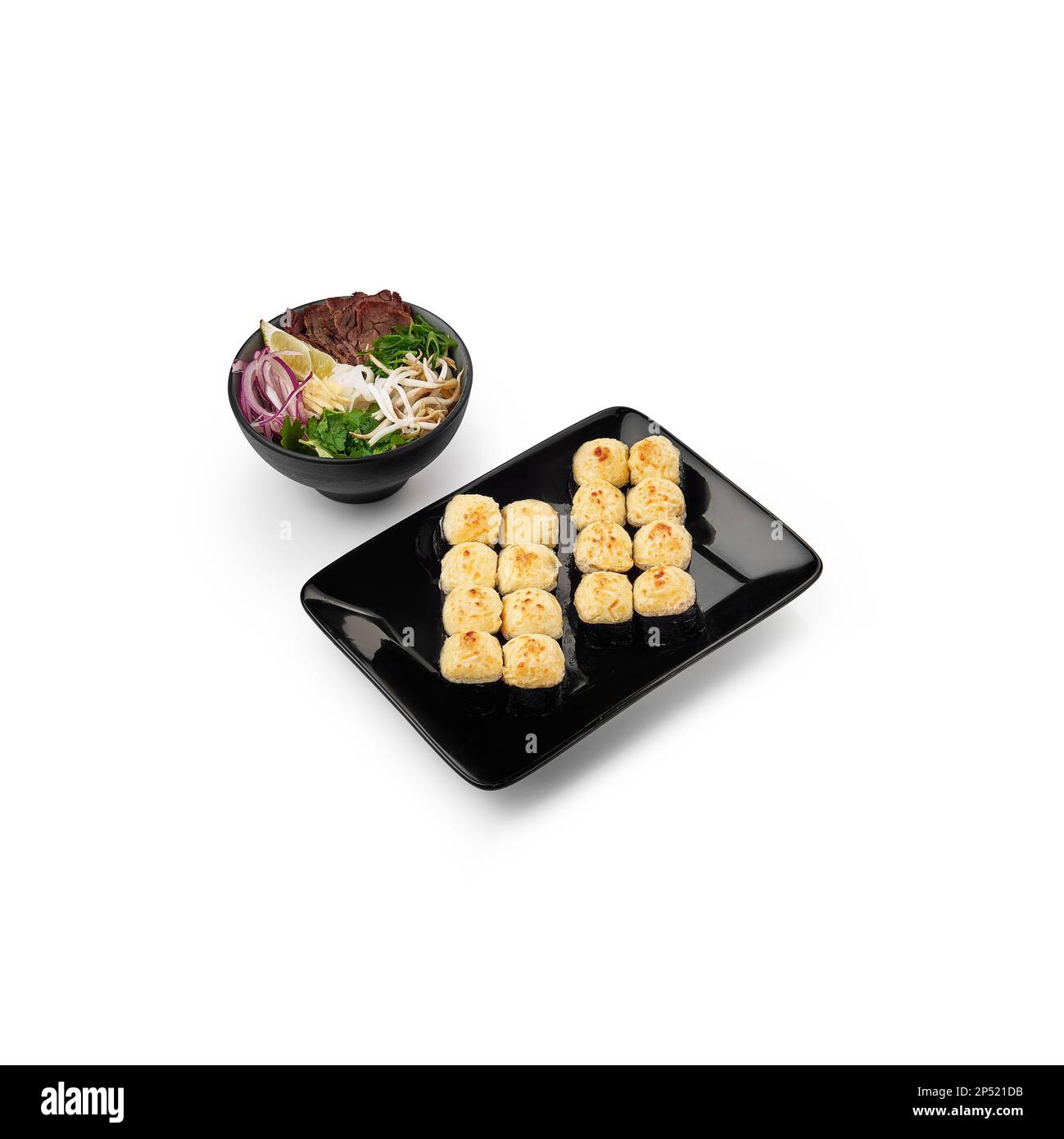 Lunch on a flat black plate white background isolate Stock Photo - Alamy