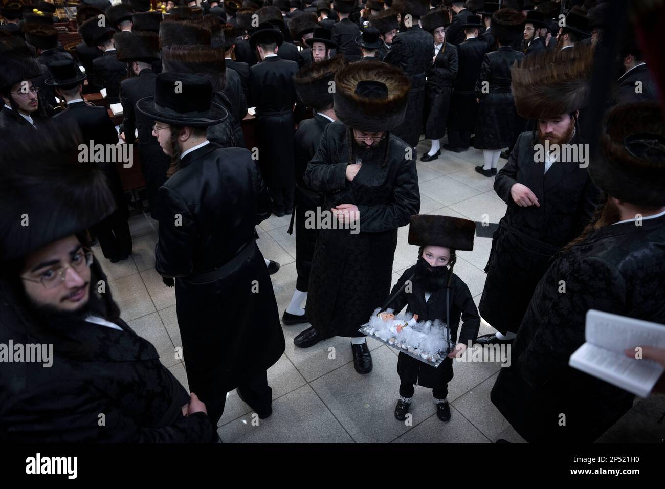 Jewish ultra-Orthodox men and children, some wearing costumes as they ...