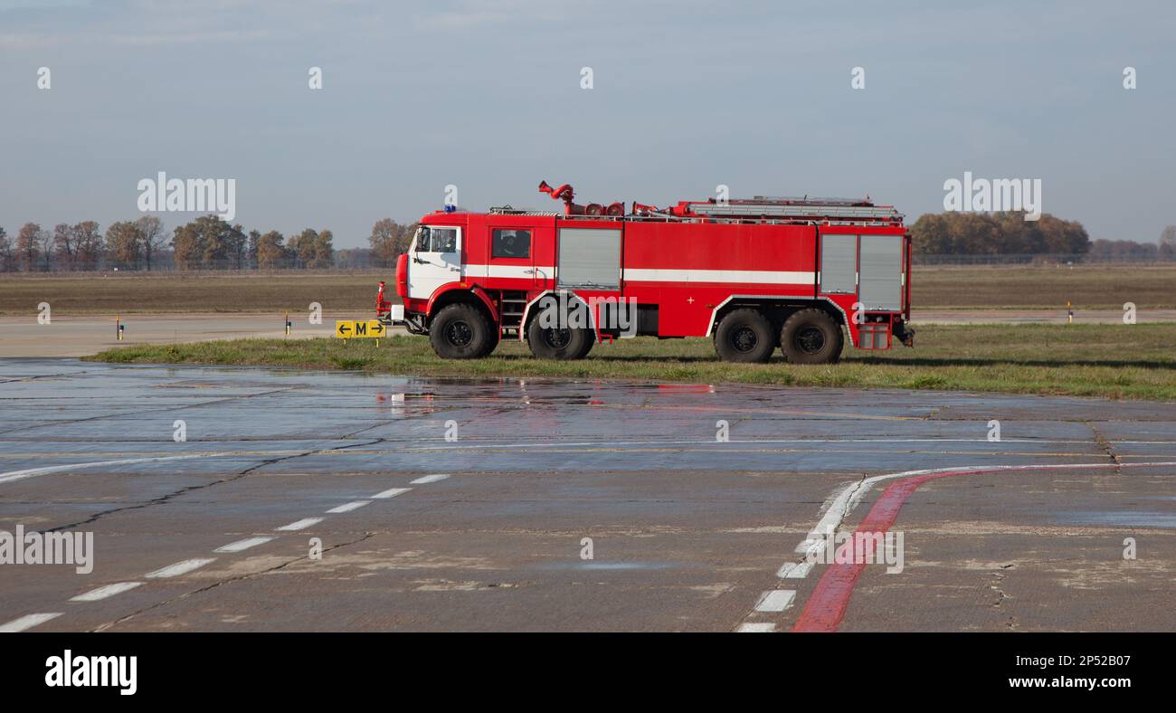 Red fire truck at the airport. Outdoor transportation car. Airport fire ...