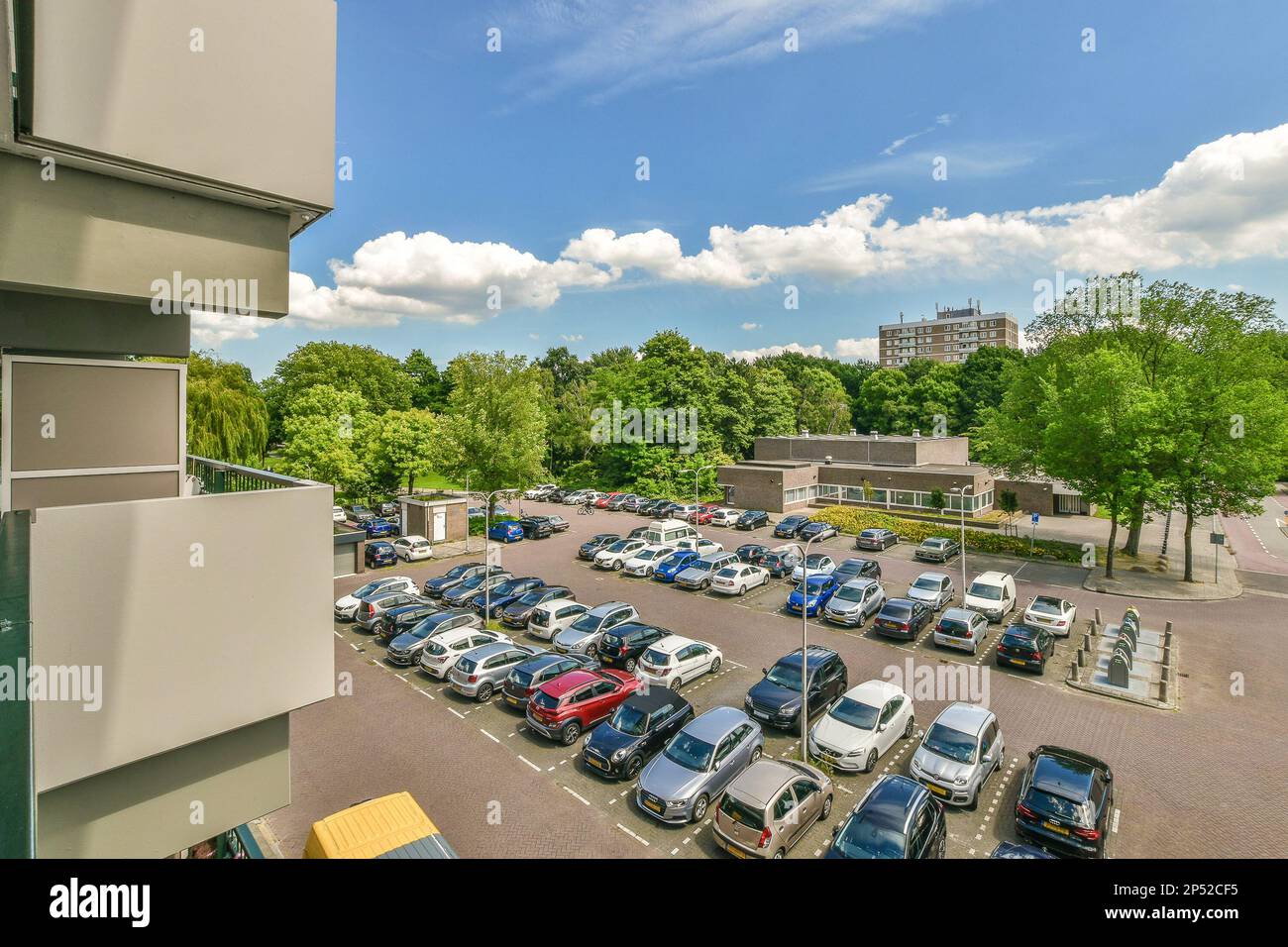 a parking lot with many cars parked in it and some buildings on the ...