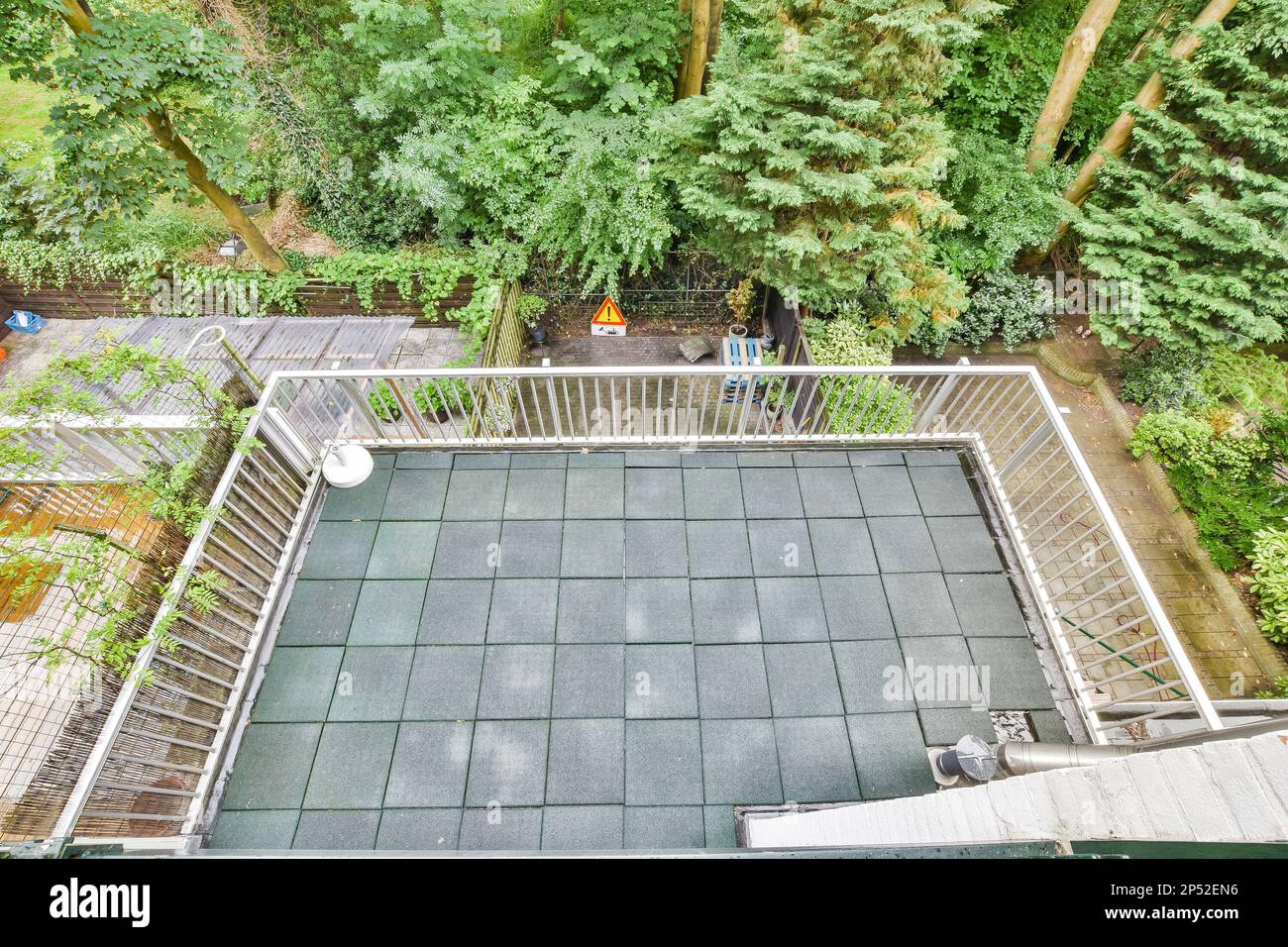 an overhead view from the top down on a backyard patio with green ...