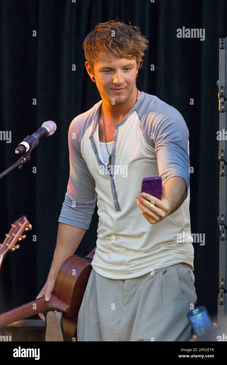 Drew Chadwick of Emblem 3 performs on stage at South Coast Plaza on ...