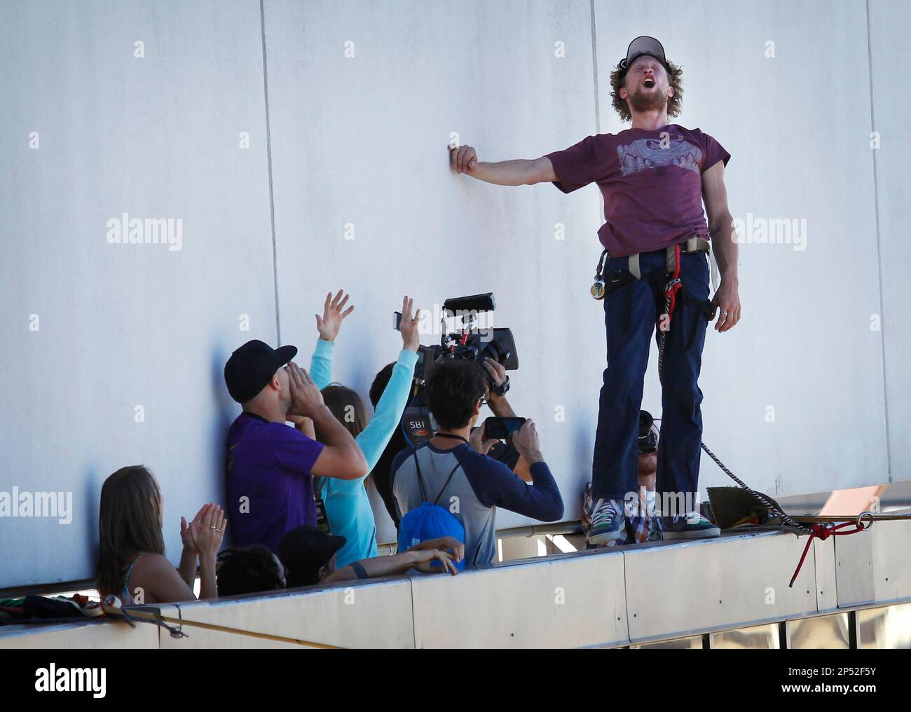 Daredevil slackline athlete Andy Lewis, right, lets out a scream after ...