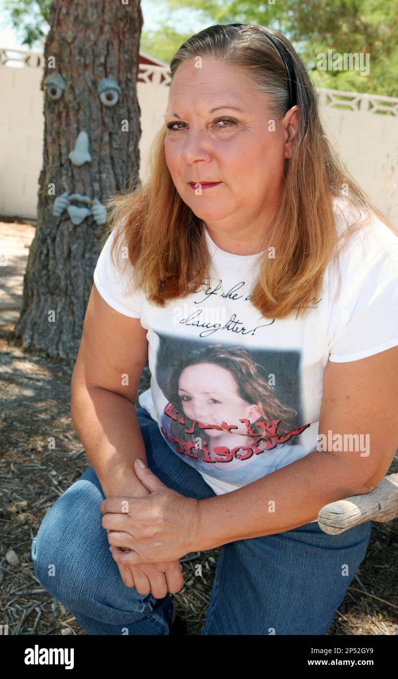 Michelle Ravell poses near a tree in the backyard of her Las Vegas home ...