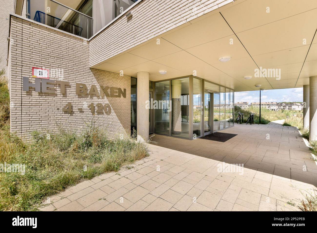 the outside of a building with an open sign on it's side and plants ...