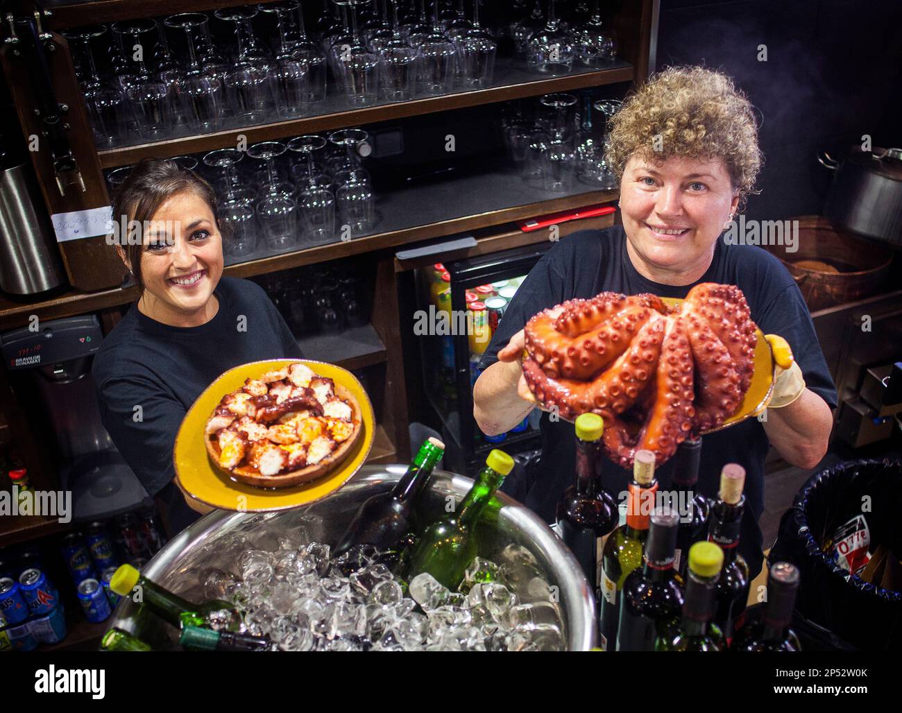 Waitresses showing at right Octopus and at left ´Pulpo a feira´ octopus ...
