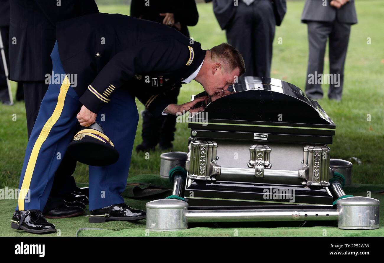 U.S. Army Reserve Capt. Chris Carbone kisses the casket containing the ...