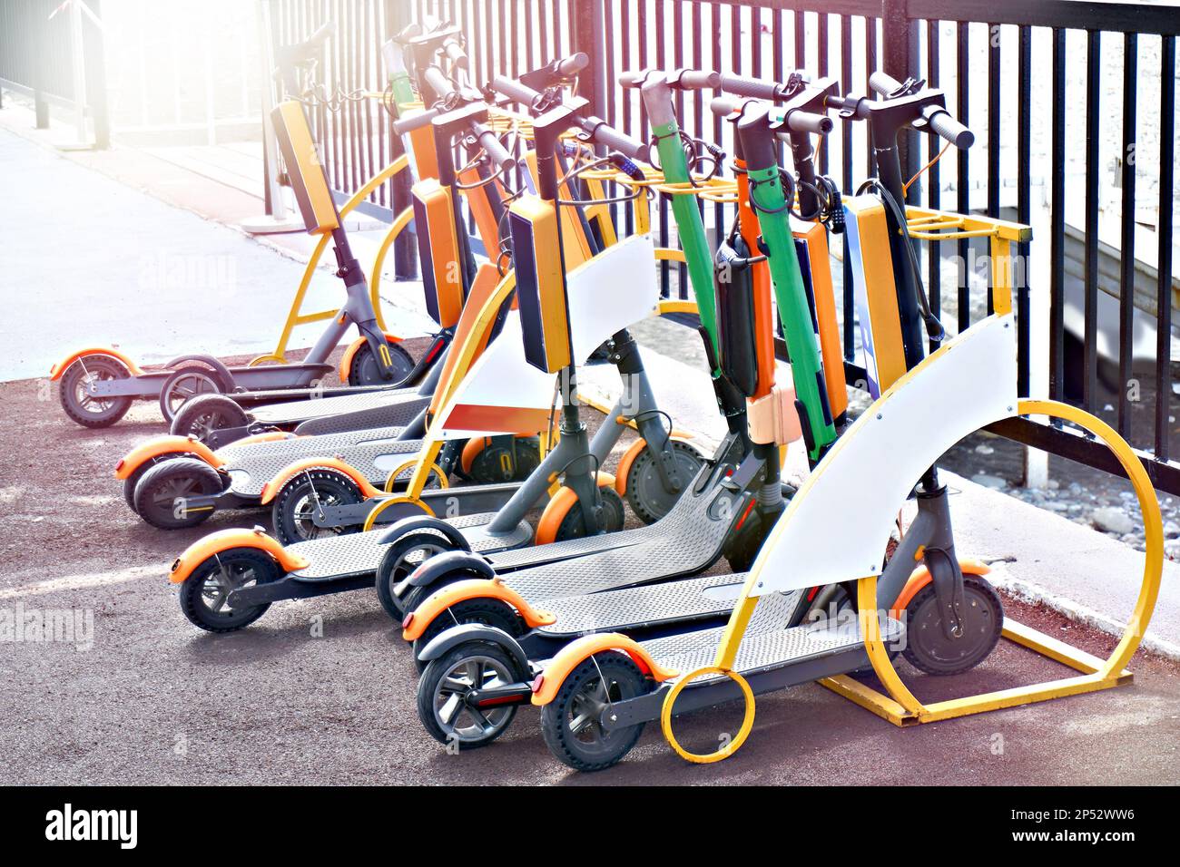 Electric push scooters for rent in the parking lot Stock Photo - Alamy