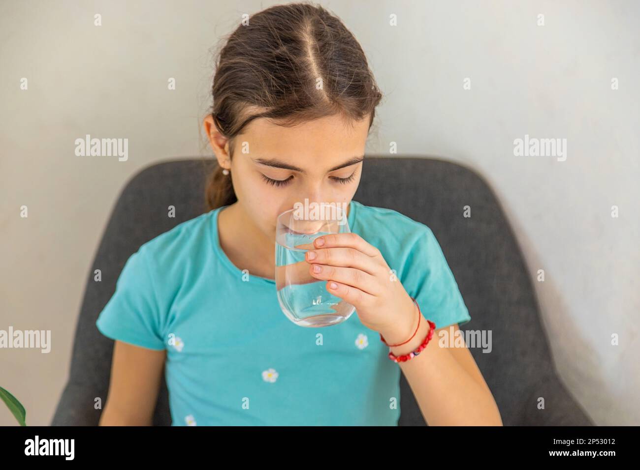 The child drinks water from a glass. Selective focus. Kid Stock Photo - Alamy
