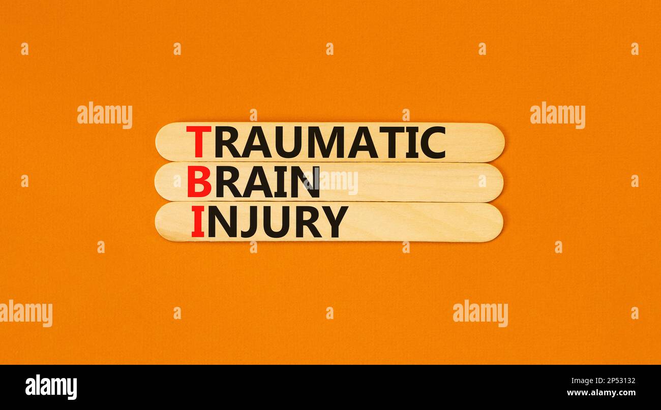 TBI traumatic brain injury symbol. Concept words TBI traumatic brain injury on wooden stick on a ...