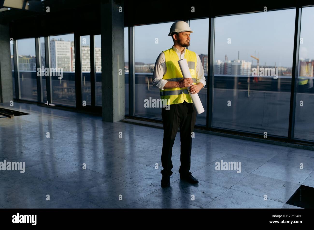 Portrait of an architect with construction drawings. contractor holding ...