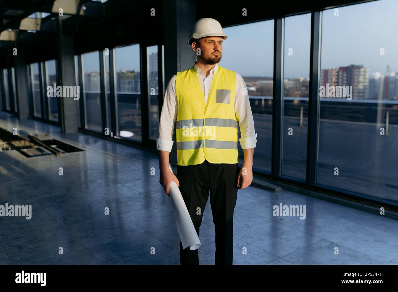 Portrait of an architect with construction drawings. contractor holding ...