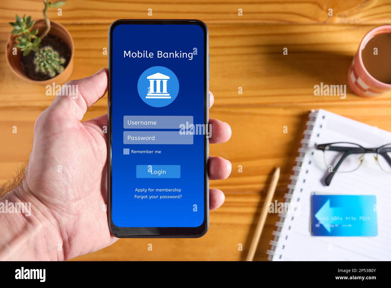 Male hand holding mobile phone with online banking app interface on the ...