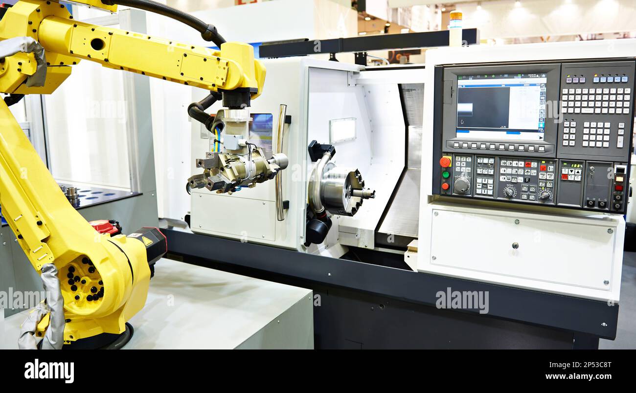 Robotic arm and cnc lathe machine Stock Photo - Alamy