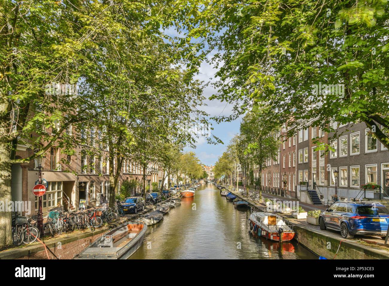 a canal with boats and houses in the background, amsterdam, netherlands ...