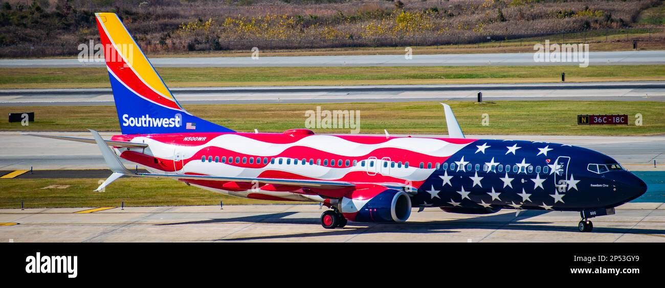 An American-themed airplane stands on the tarmac, its fuselage painted ...
