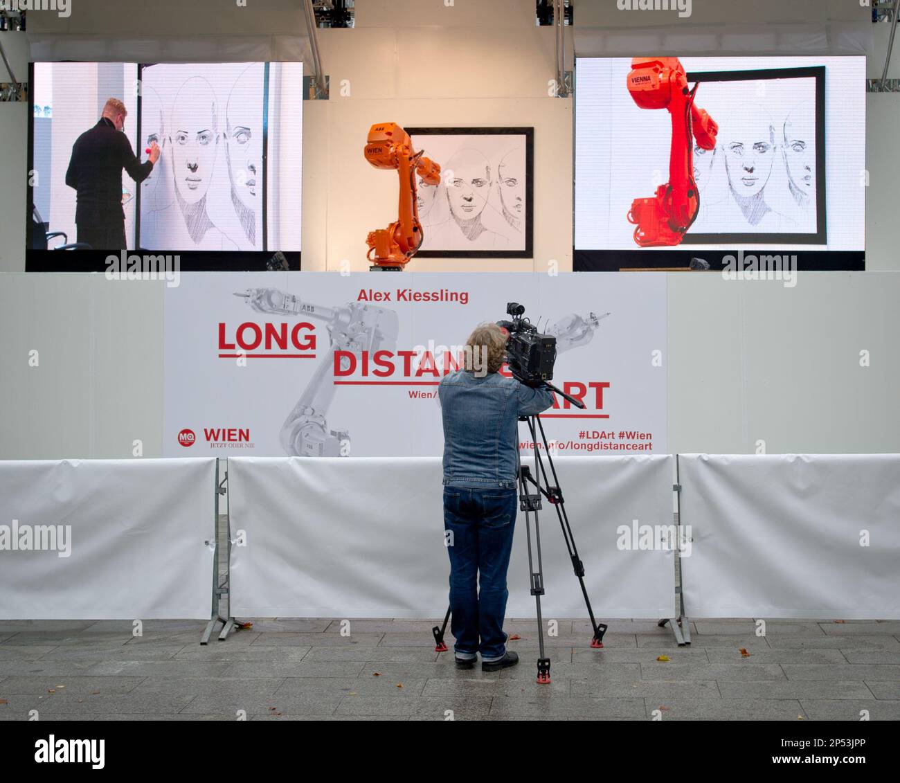 A remote controlled robot, center draws a part of the artwork ...