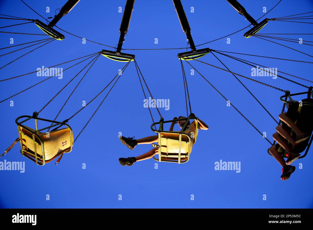 Kaleb Isbell kicks out his legs while enjoying a swing ride called the ...