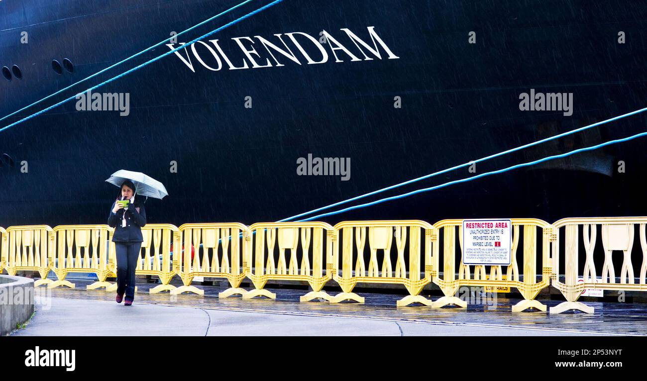Veronica Samson, a crew member of the Volendam, takes pictures in ...