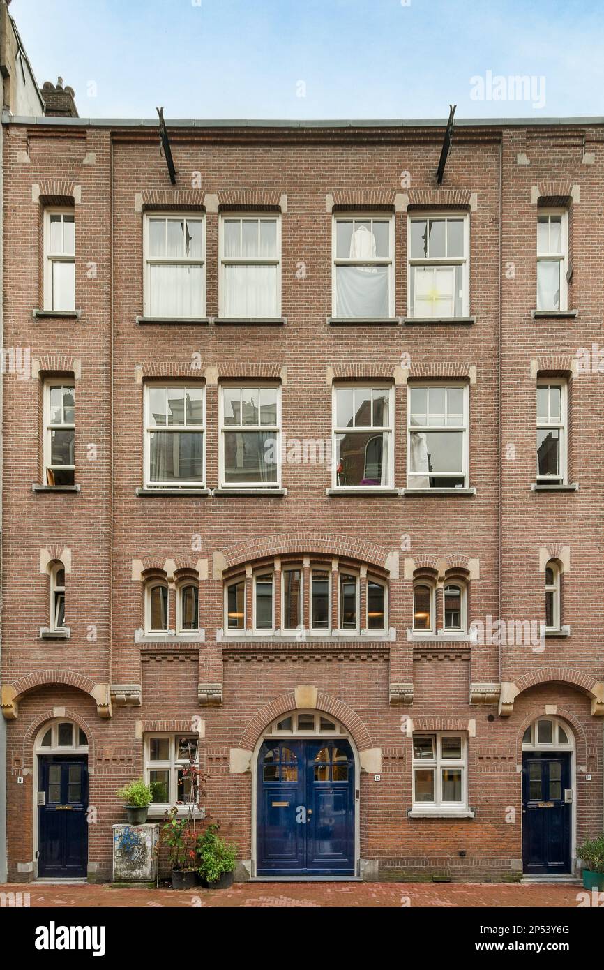 a brick building with two blue doors on the front and one door open to ...