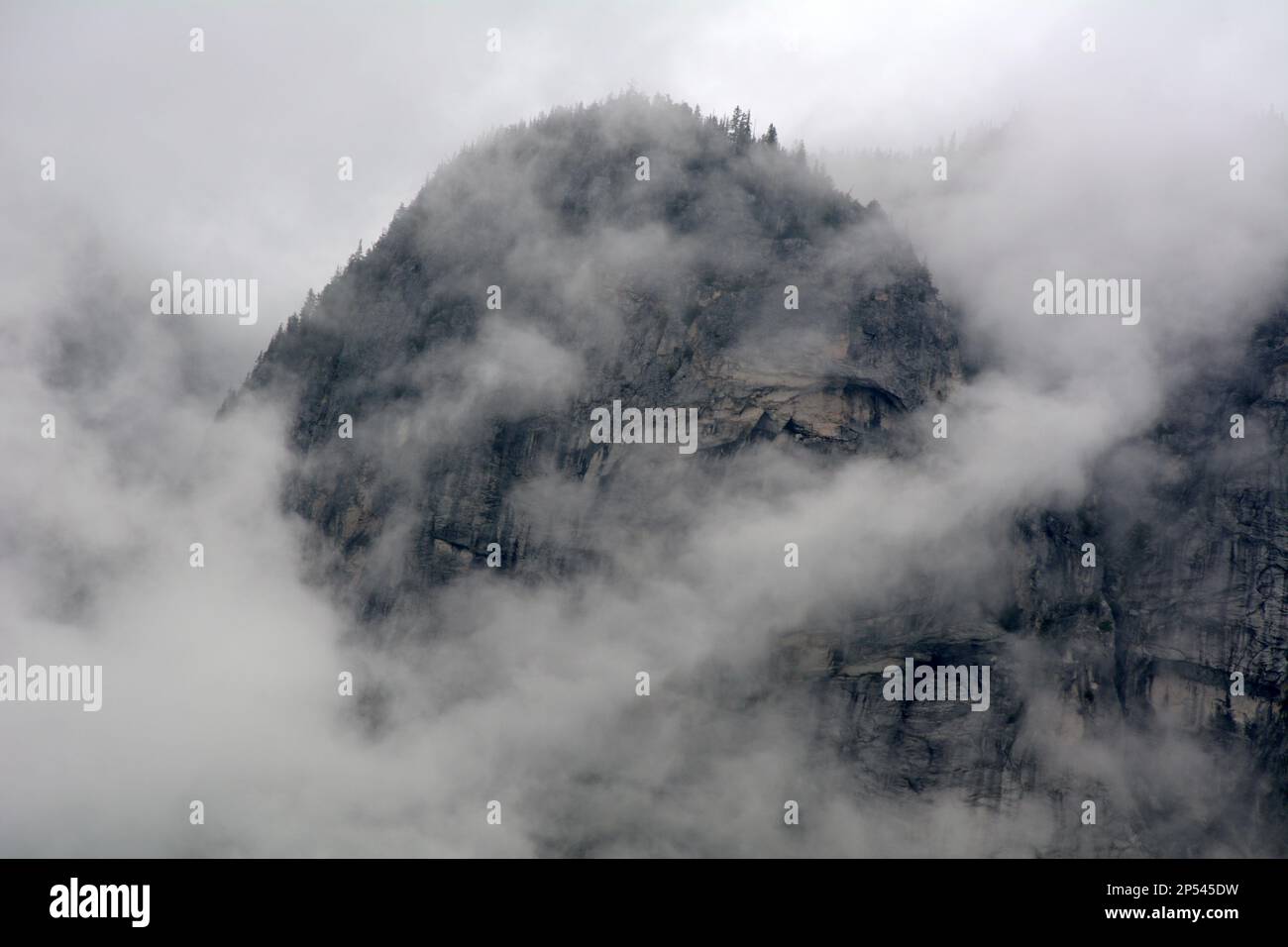 The misty rocky cliffs and slopes of Hope Mountain, in the Skagit ...