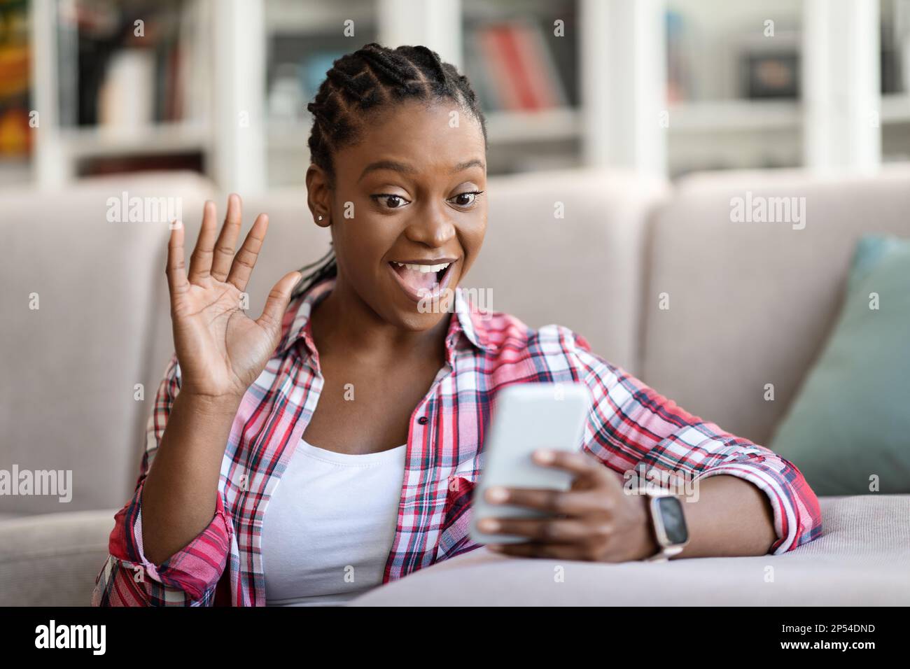 Happy young black lady have video call with friends Stock Photo - Alamy