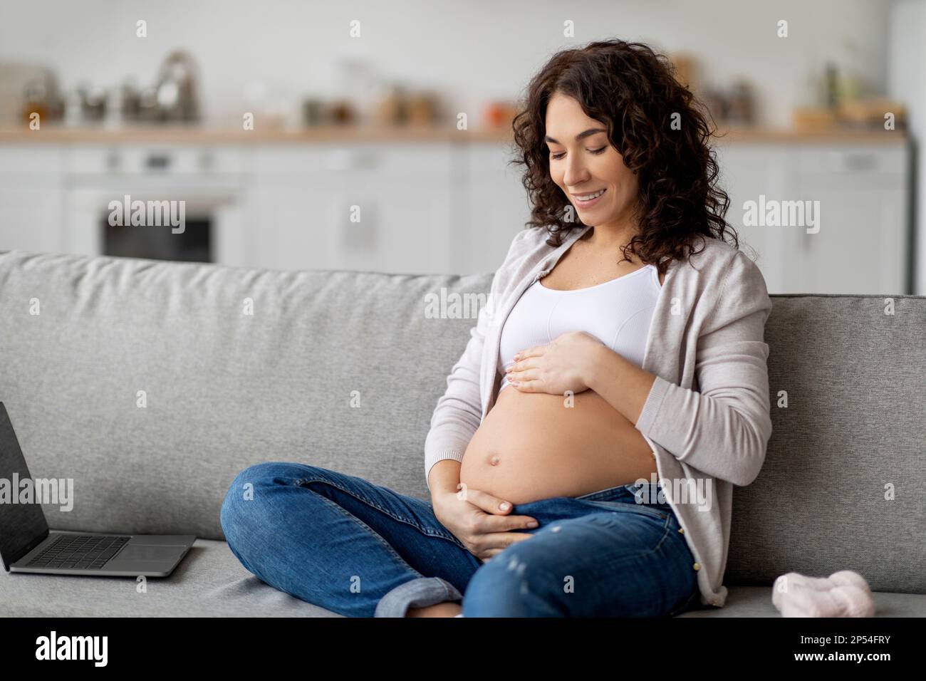 Pregnancy Time. Beautiful Pregnant Woman Sitting On Couch And Caressing ...