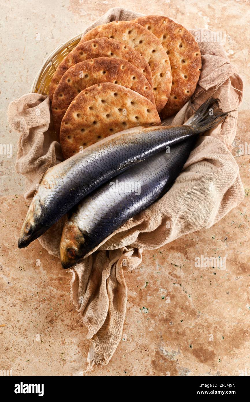 Catholic still life of five loaves of bread and two fish Stock Photo ...