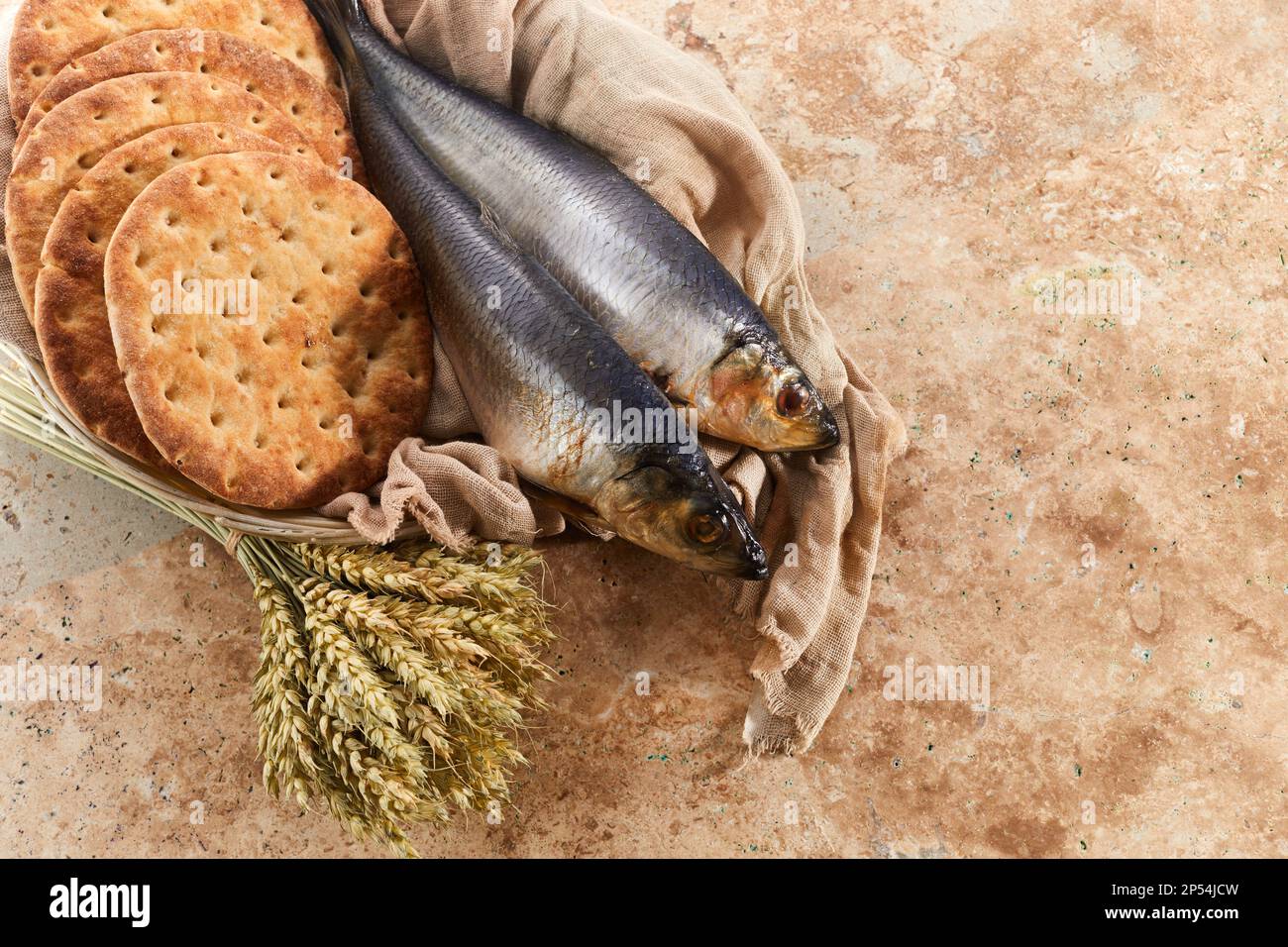 Catholic still life of five loaves of bread and two fish Stock Photo ...
