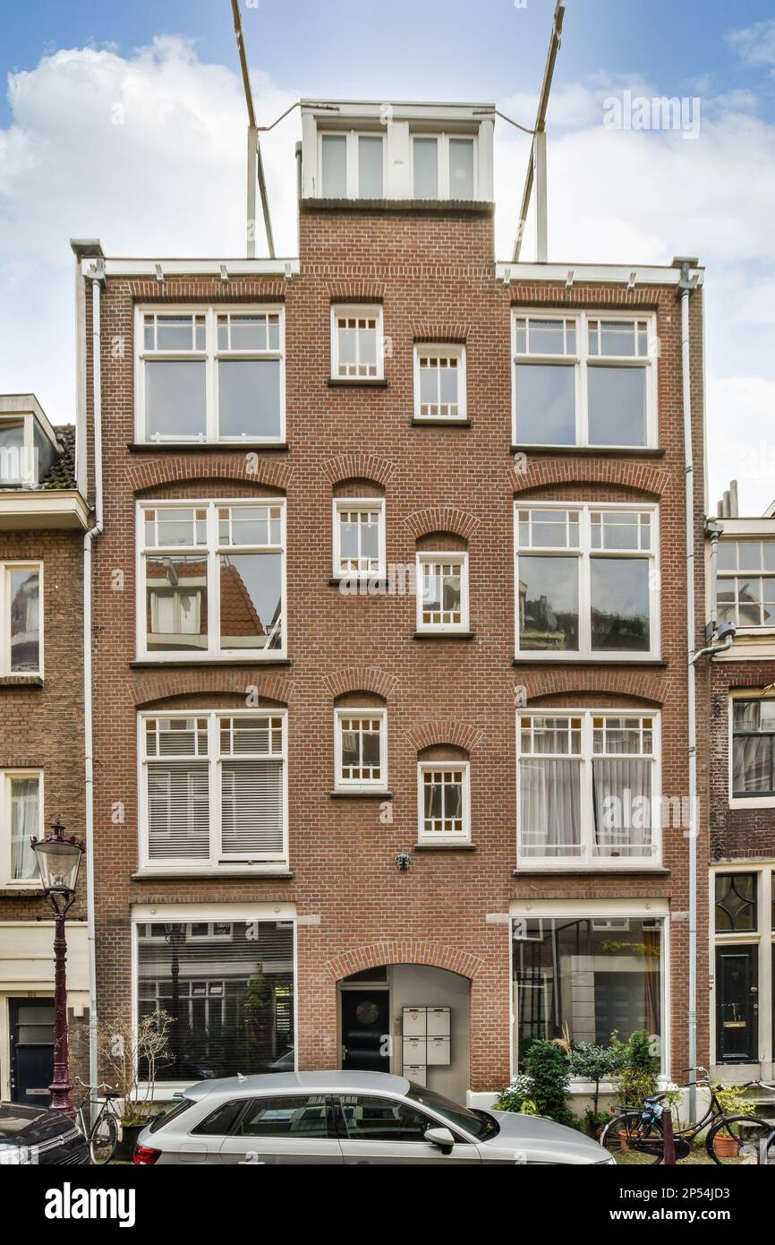 an apartment building with cars parked on the street next to it and ...