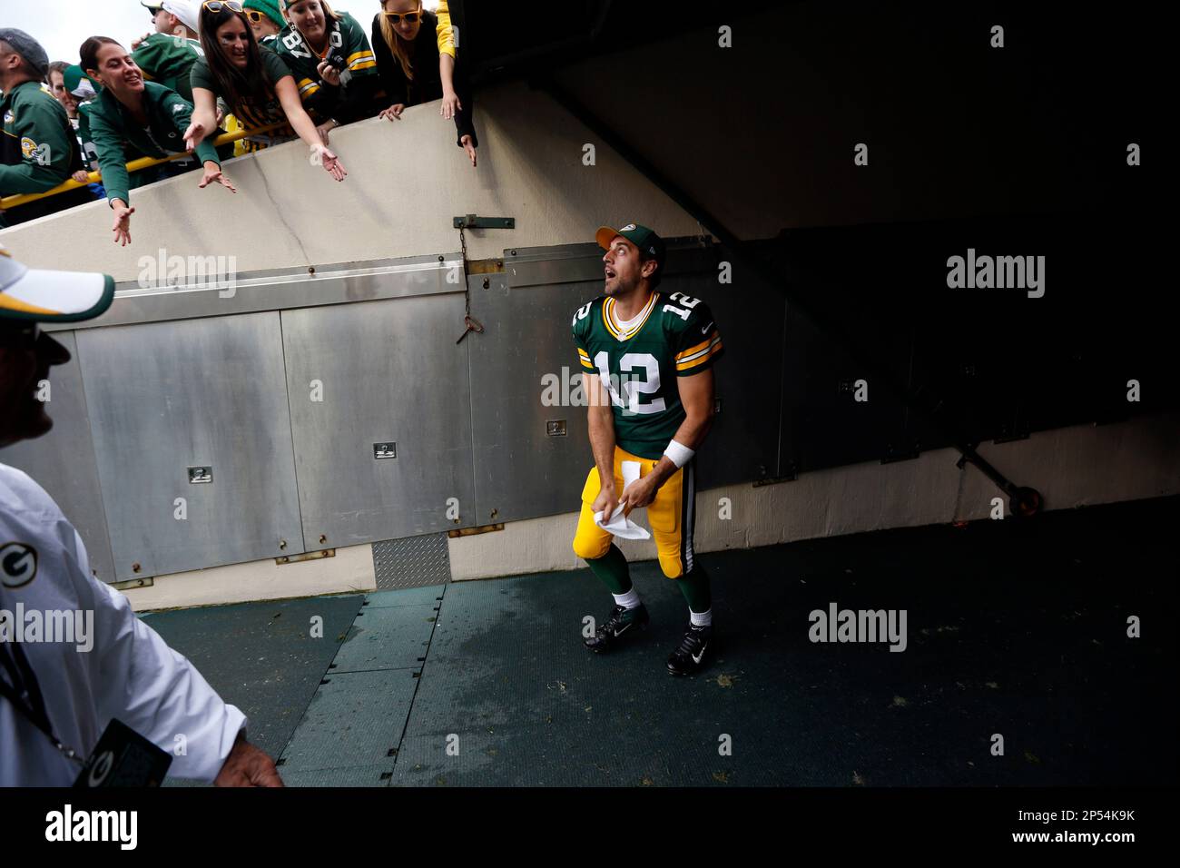 Green Bay Packers' Aaron Rodgers throws his towel to some fans after an ...