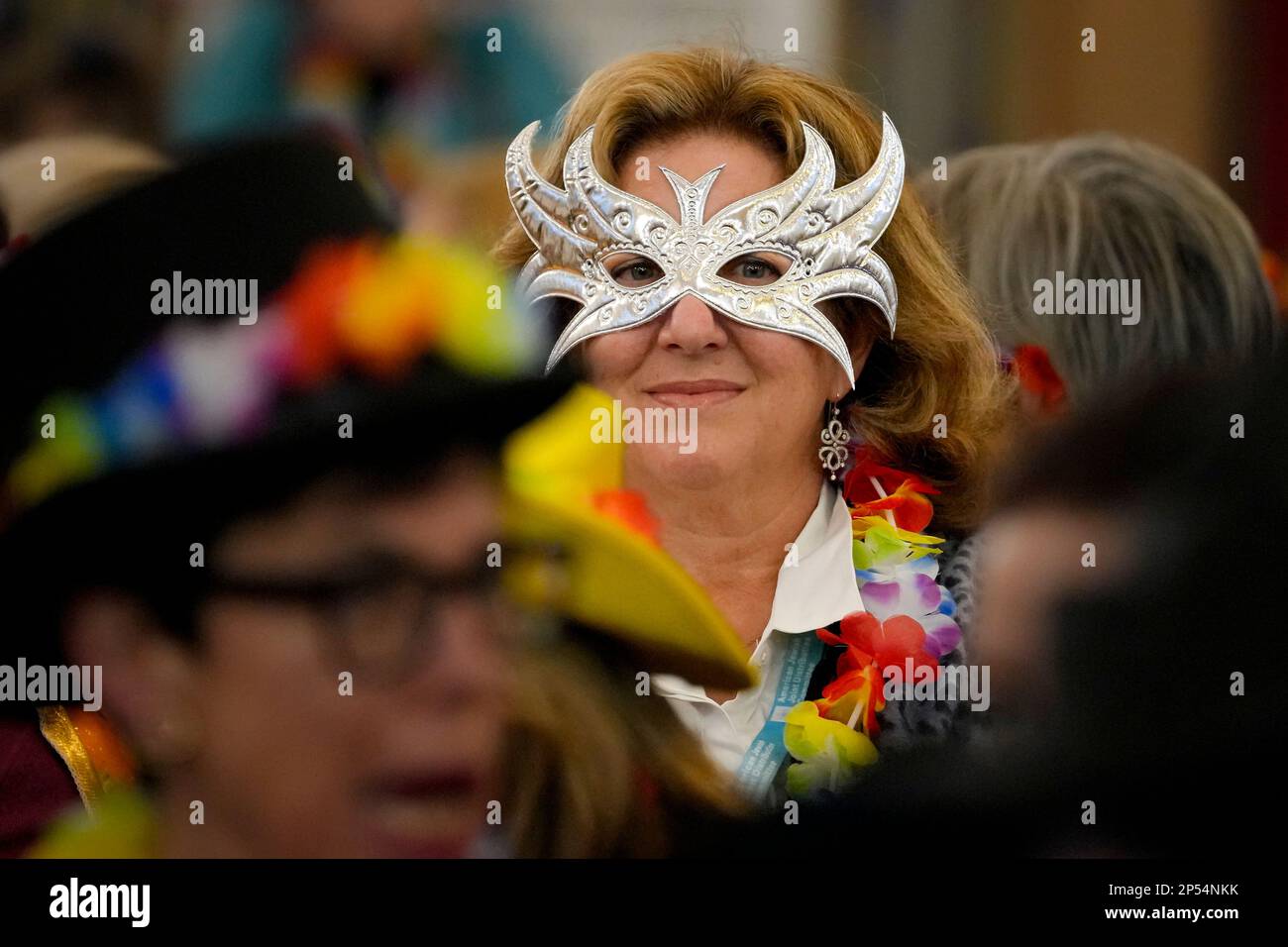 A woman wearing a mask smiles as Romania's Jewish community celebrates ...