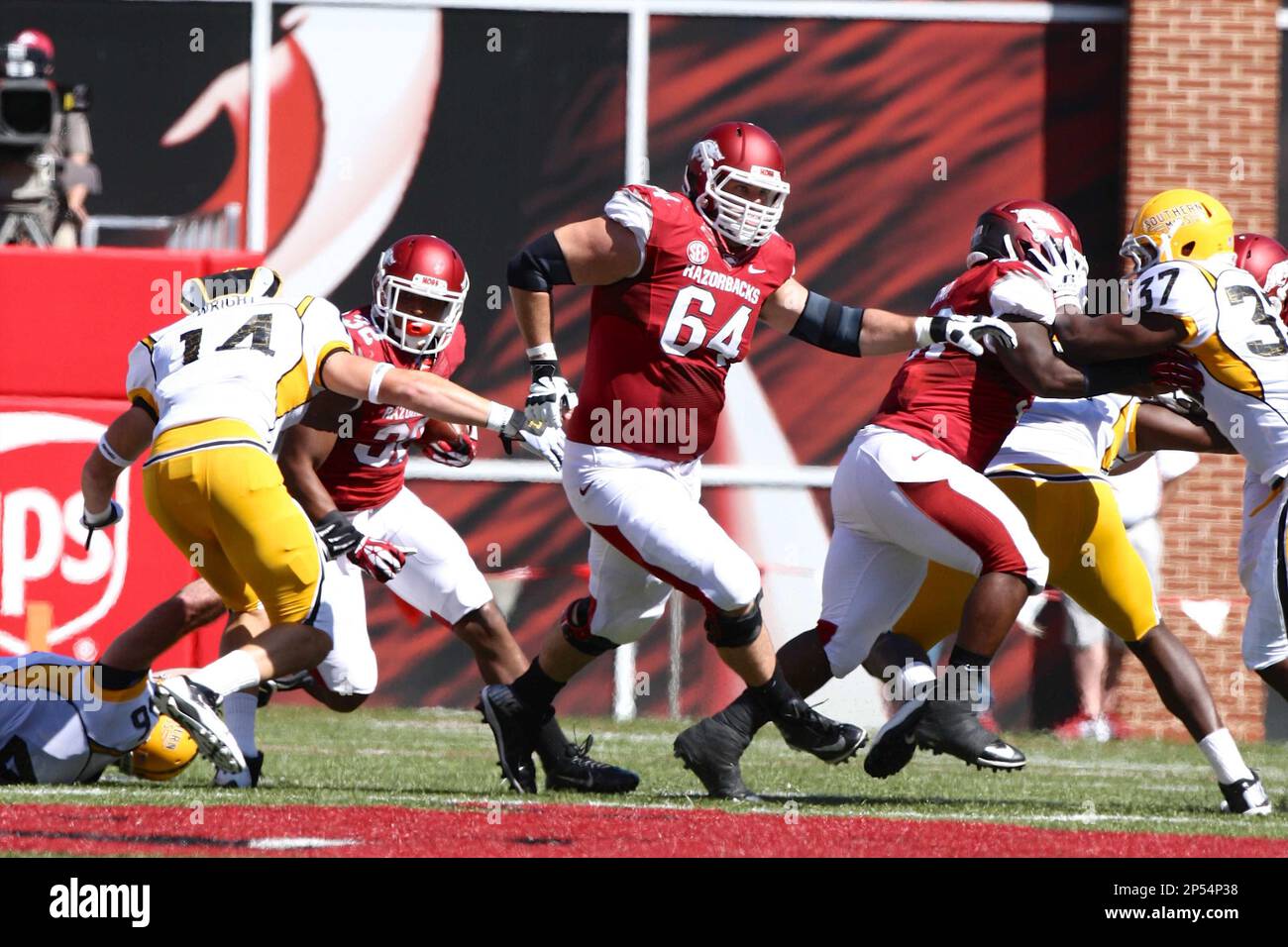 Sept. 14, 2013: Razorback center Travis Swanson #64 works to clear a ...