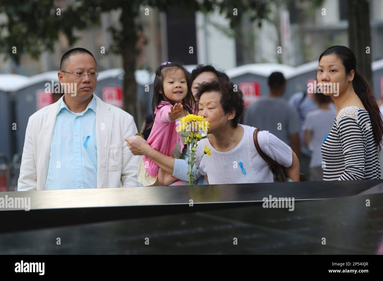 Family members of Ji Yao Justin Zhao pay their respect at a ceremony ...