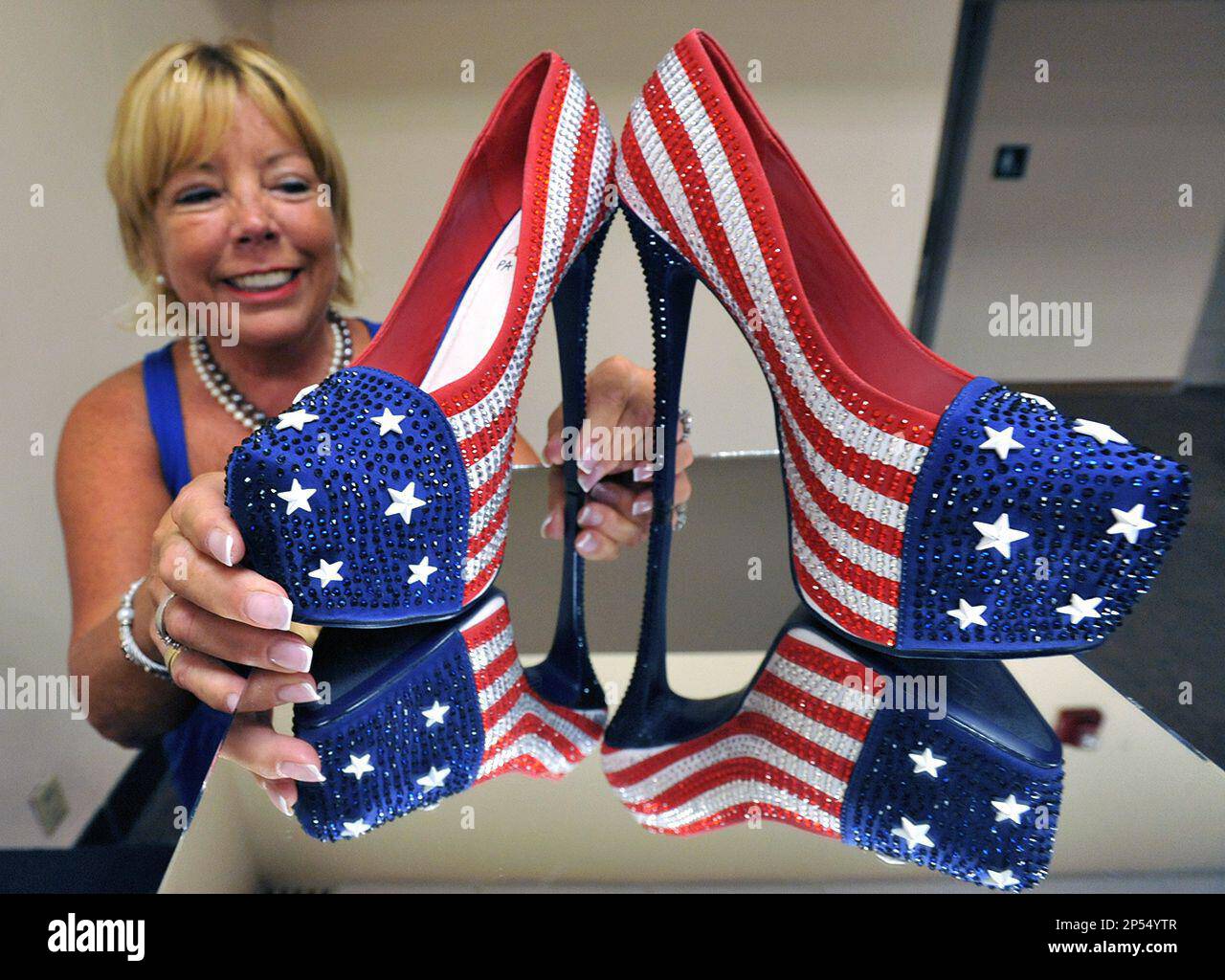 Miss America volunteer Fran McManus, looks at the shoes Miss ...