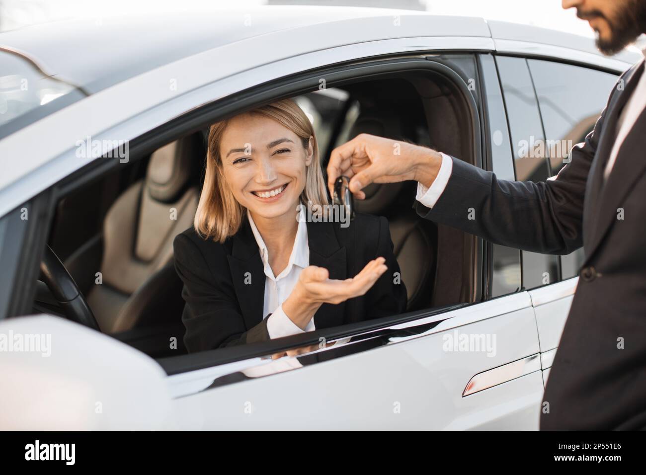 Charming caucasian woman in formal wear siding inside her luxury new ...