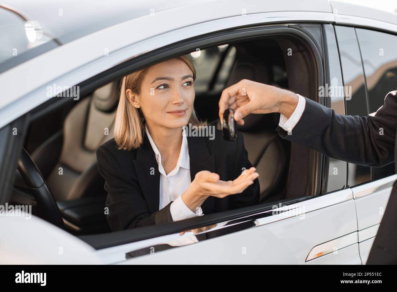 Charming caucasian woman in formal wear siding inside her luxury new ...
