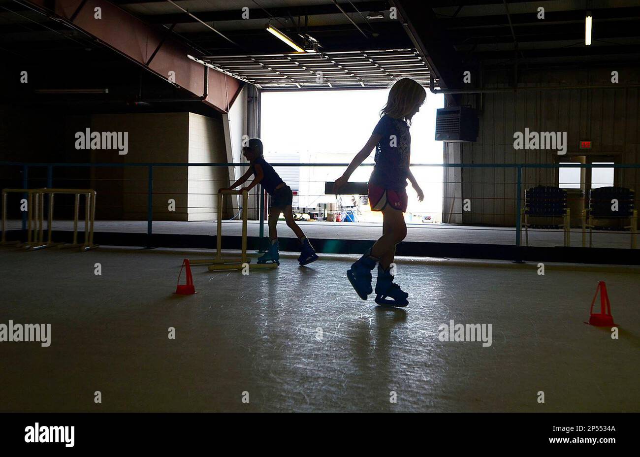 Paige Gehring, 7, left, and Jordan Sylvester, 9, skate on the Glide ...