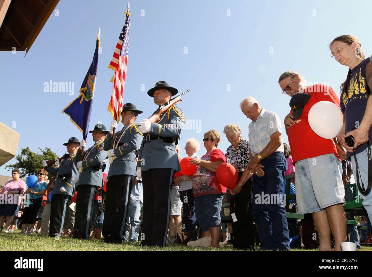 People bow their heads during the Kansas State Fair opening ceremony ...